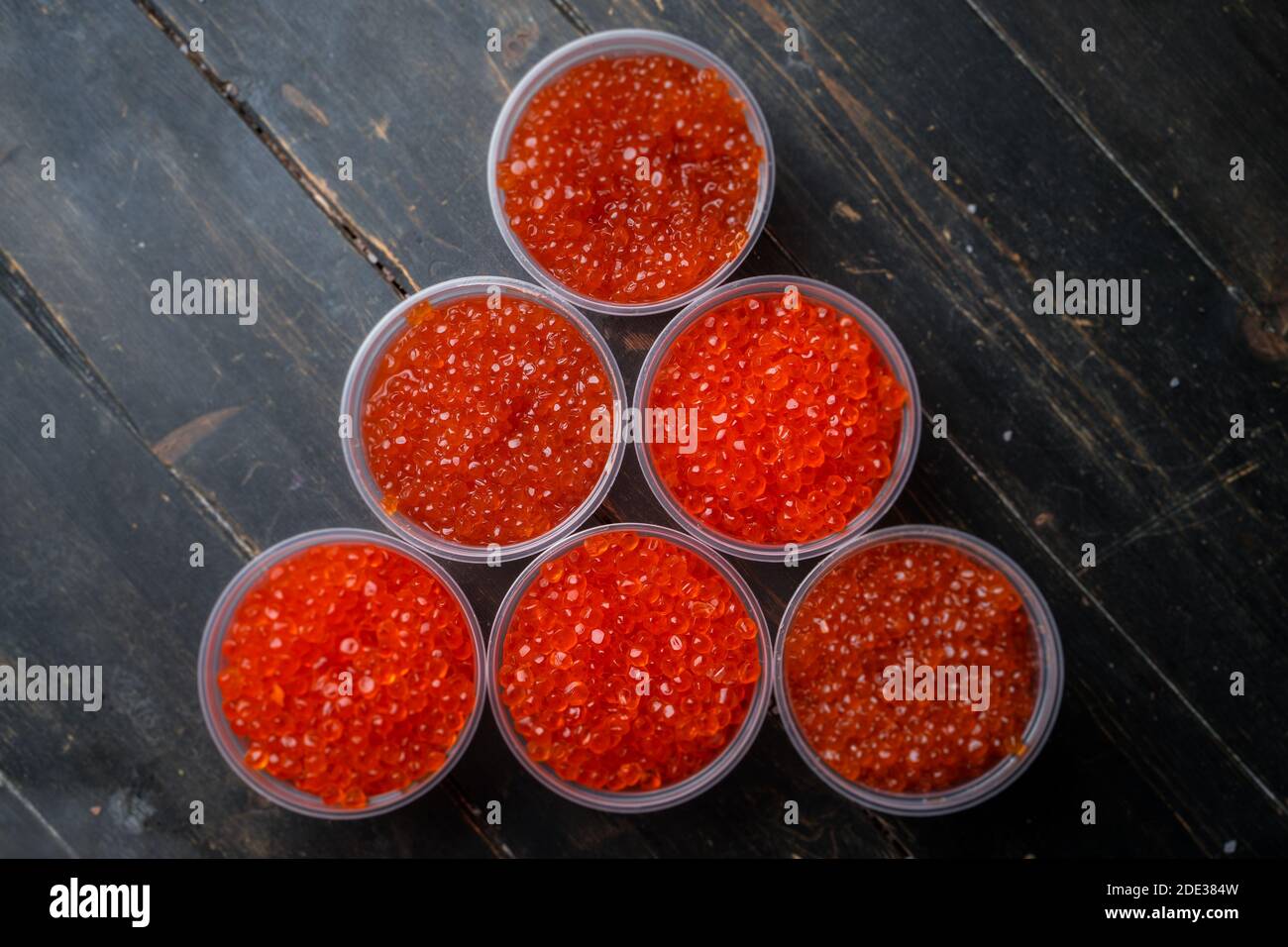 Pink salmon caviar and chum salmon caviar in plastic containers ...