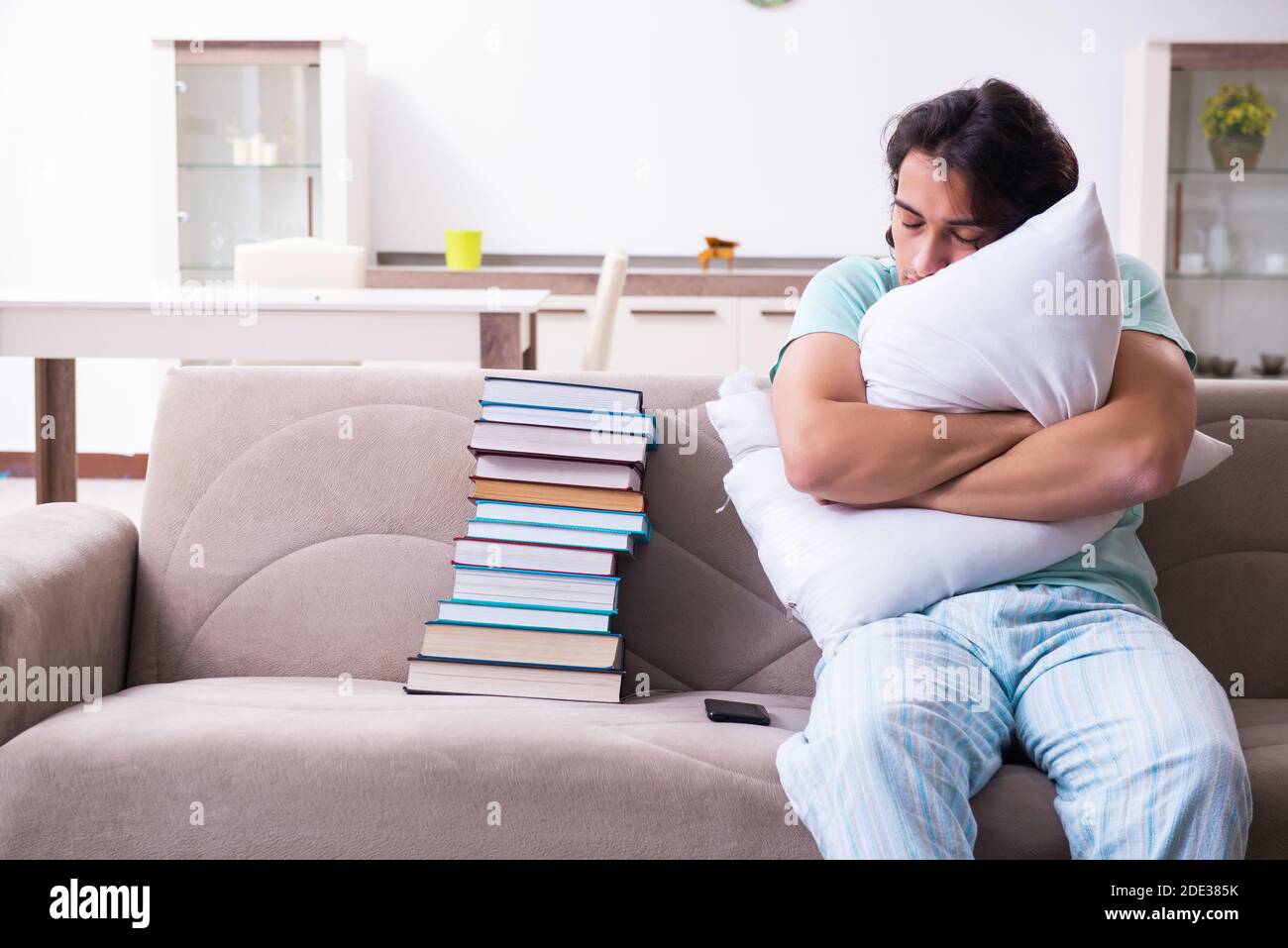 Young student being tired preparing for exams at home Stock Photo - Alamy