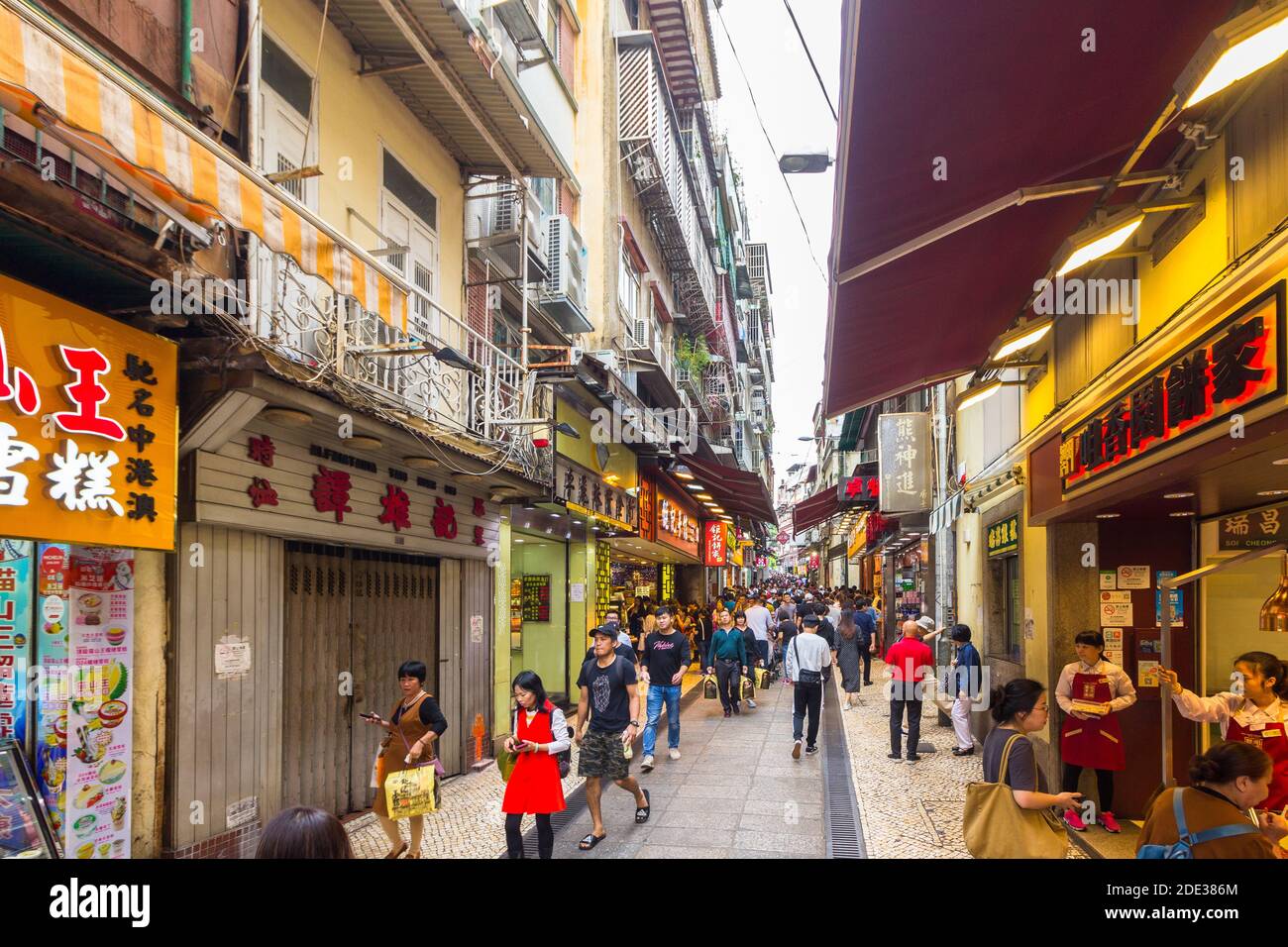 A narrow street lined with shops in Macau, China Stock Photo - Alamy