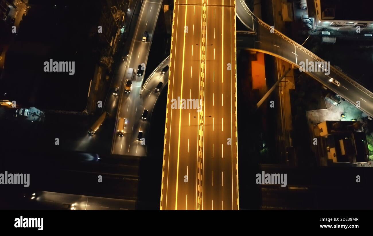 Closeup traffic road with cars, trucks drive at night top down aerial ...