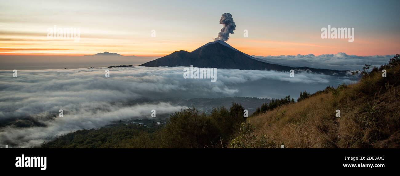 Volcano eruption at sunrise. Mount Agung, Bali, Indonesia Stock Photo ...