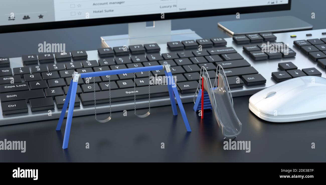 Playground slider and swing set on an office desk, computer keyboard ...