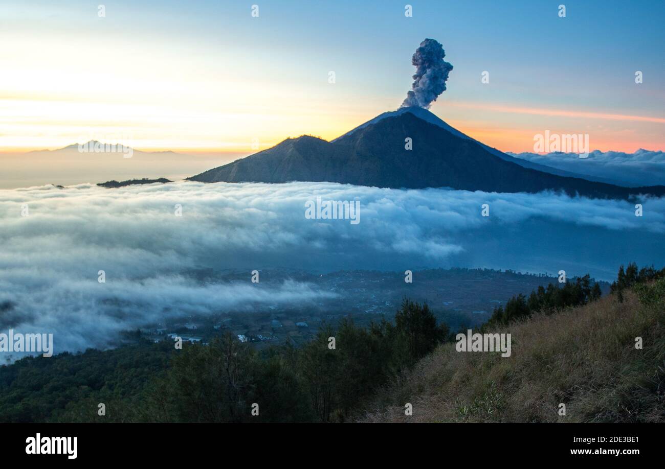 Volcano eruption at sunrise. Mount Agung, Bali, Indonesia Stock Photo ...