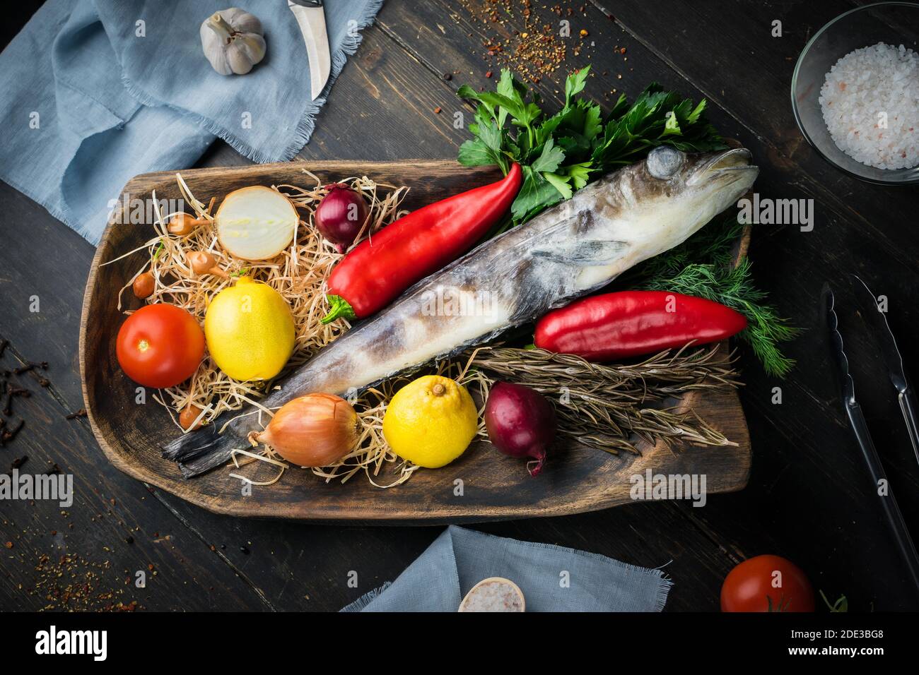 Mackerel icefish with ingredients for cooking in a wooden bowl Stock ...