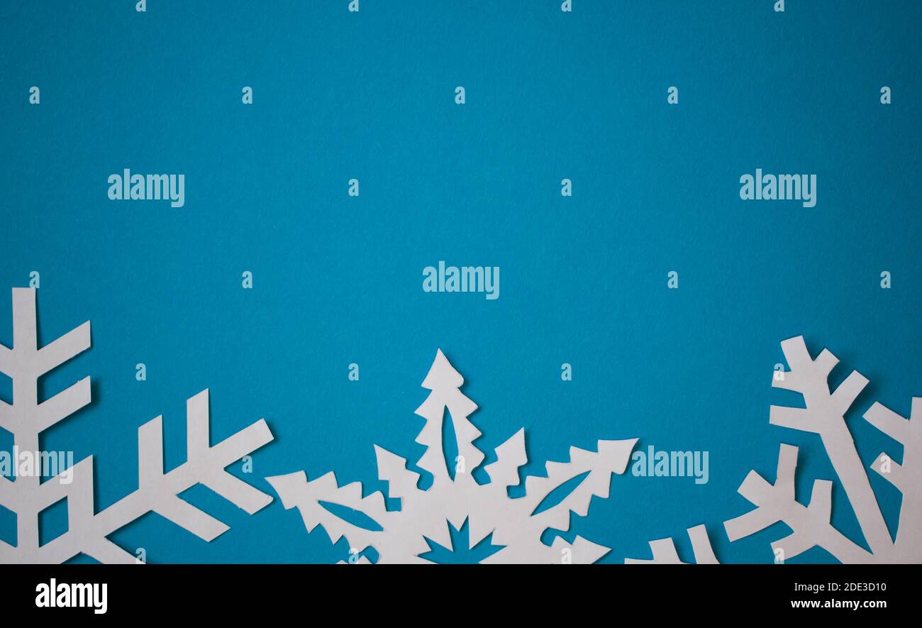 Blue background with paper white snowflakes Stock Photo - Alamy