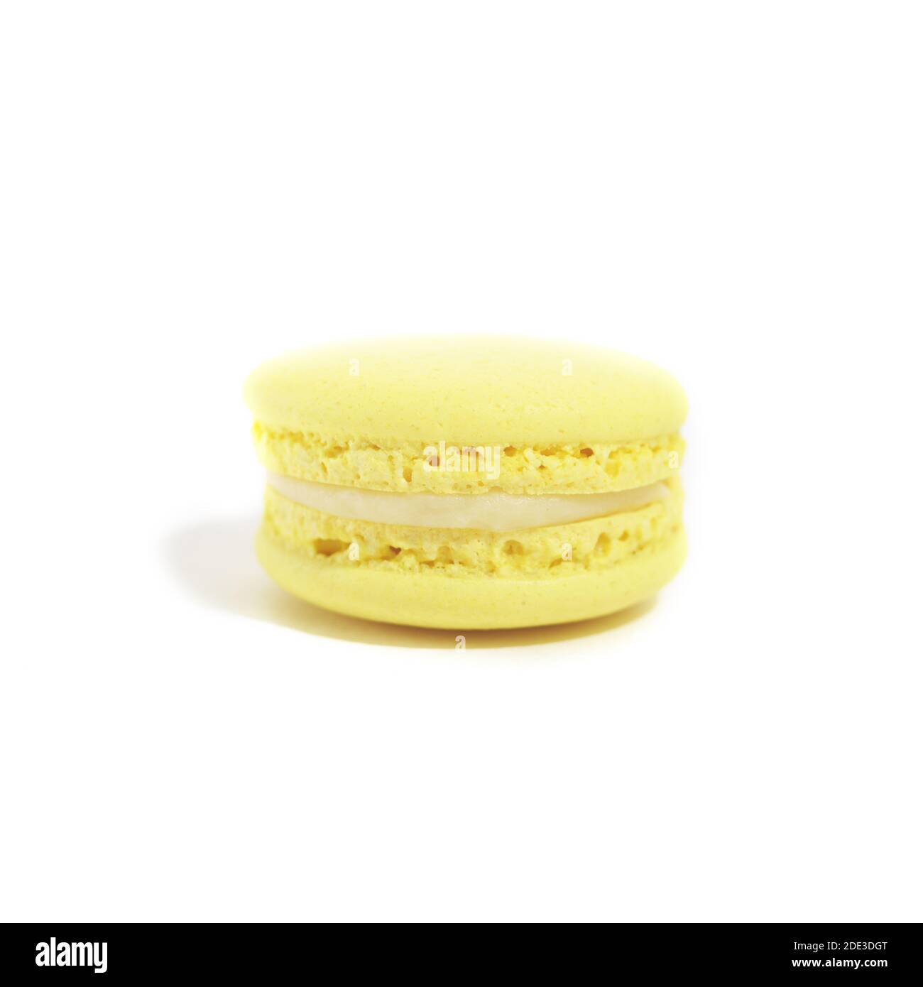 One tasty french yellow macaron isolated on the white background ...