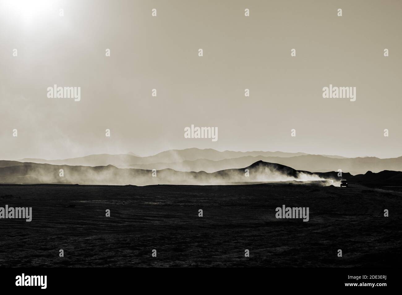 Car driving through desert landscape, rising dust cloud Stock Photo - Alamy