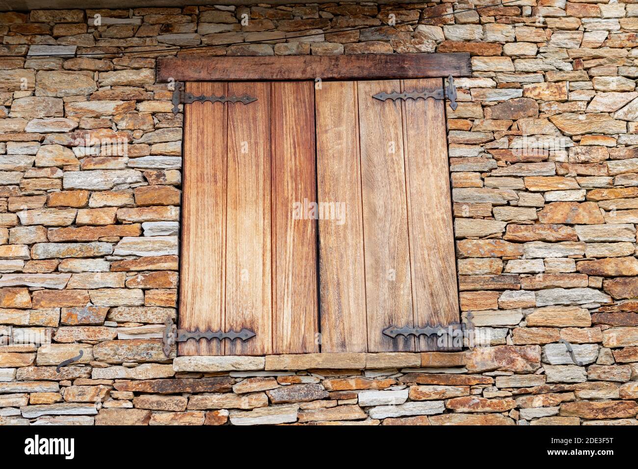 Closed wooden window on a nice stone wall Stock Photo - Alamy