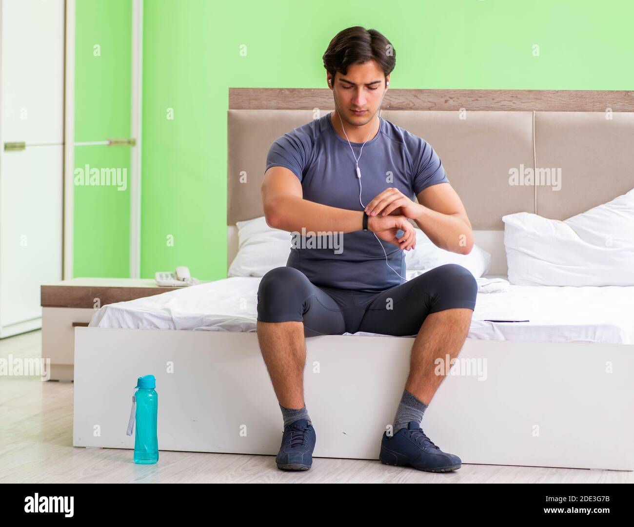 The young handsome man doing morning exercises in the hotel room Stock ...