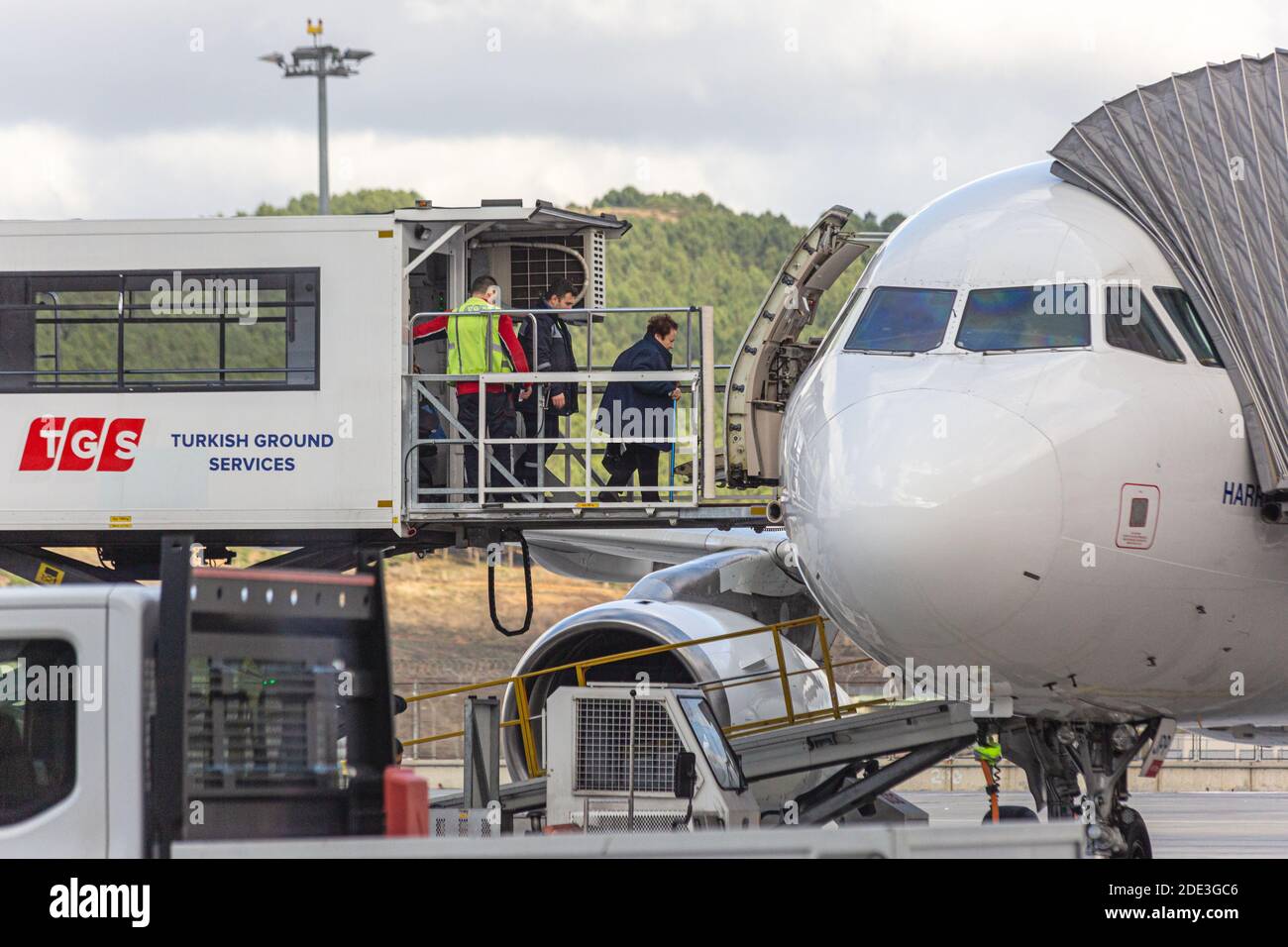 Elder people with reduced mobility boarding to an airplane from ...