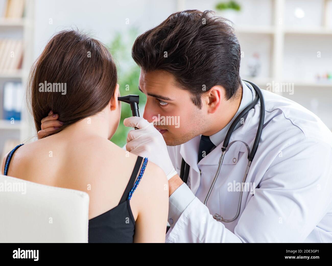 The doctor checking patients ear during medical examination Stock Photo ...