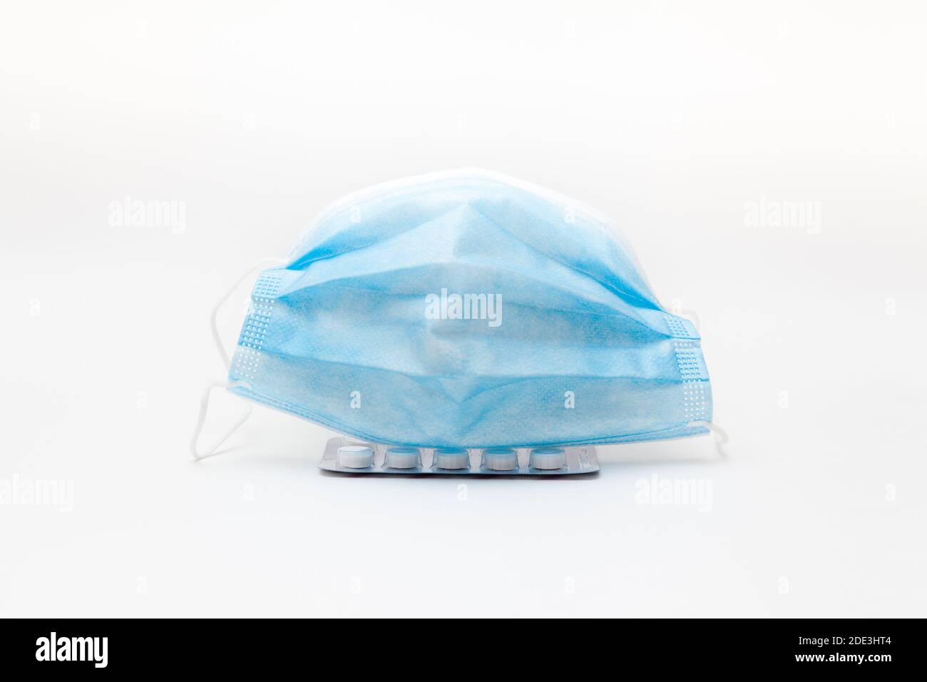 Blue protective mask on blister of tablets Stock Photo - Alamy