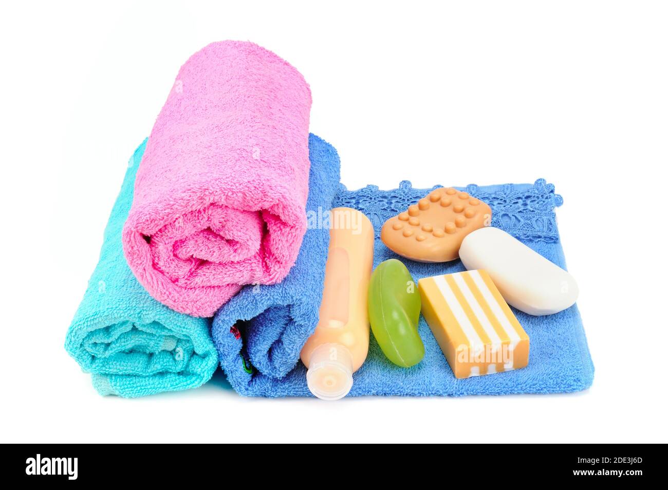 Cotton towels, cosmetic soap and shampoo isolated on white background ...