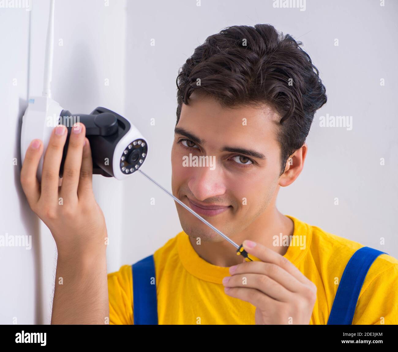 The contractor installing surveillance cctv cameras in office Stock ...