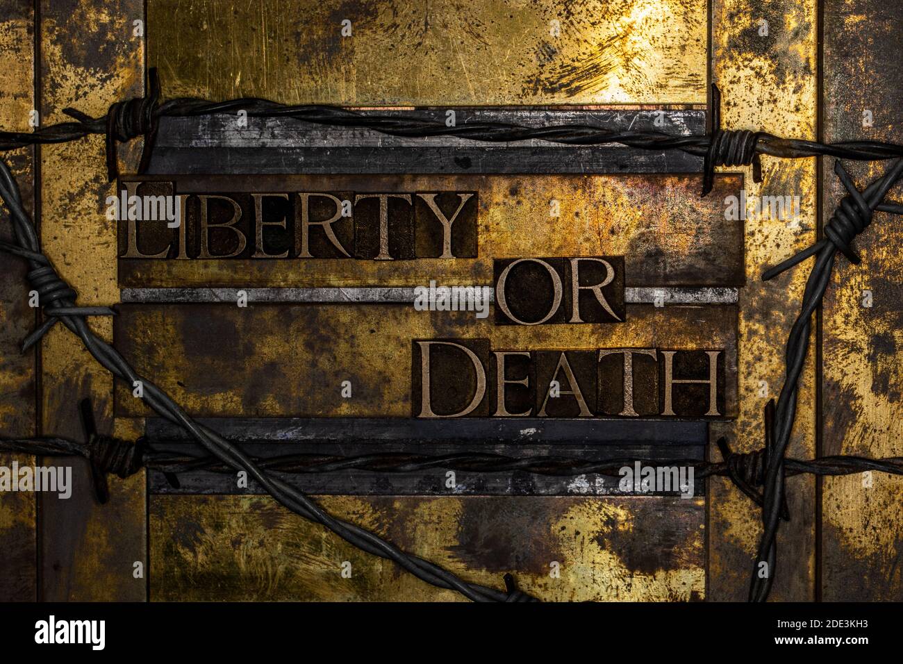 Liberty Or Death text with barbed wire on textured grunge copper and ...