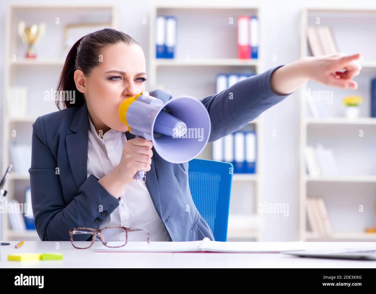 The angry businesswoman yelling with loudspeaker in office Stock Photo ...