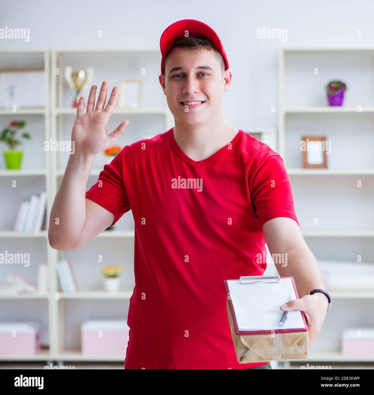 The post man delivering a parcel package Stock Photo - Alamy