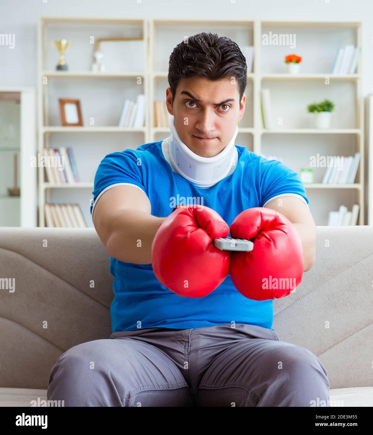 The man with neck injury watching boxing at home Stock Photo - Alamy