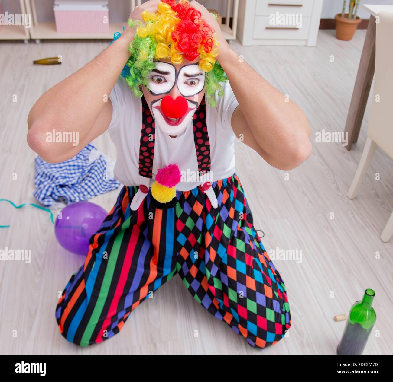 Drunk clown celebrating having a party at home Stock Photo - Alamy