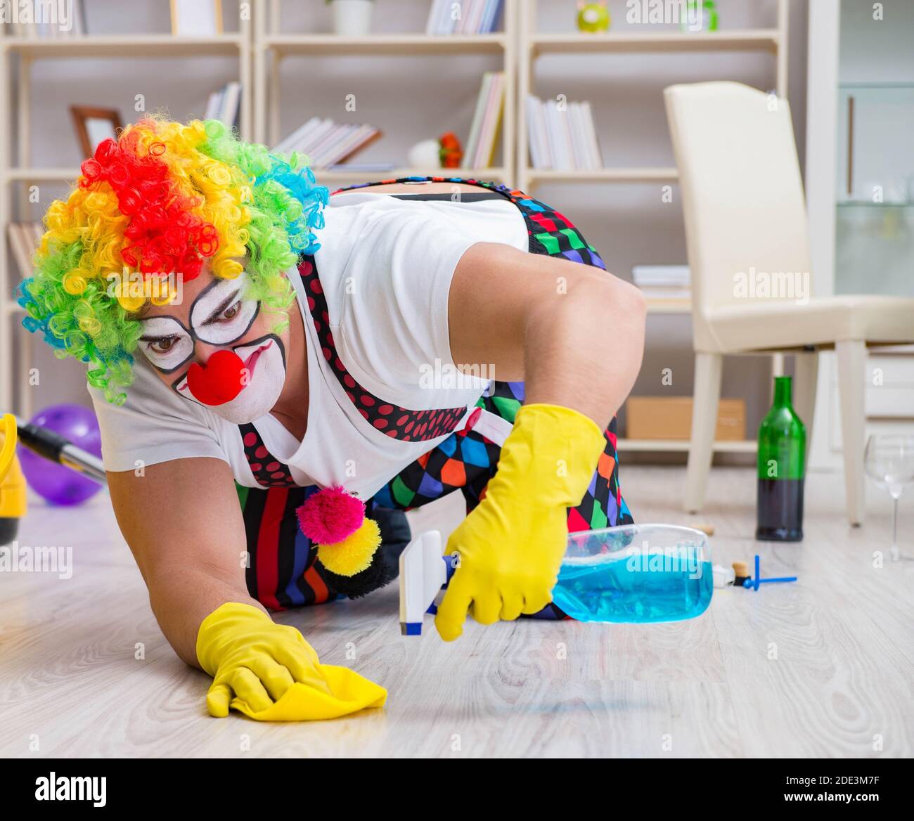 Funny clown doing cleaning at home Stock Photo - Alamy