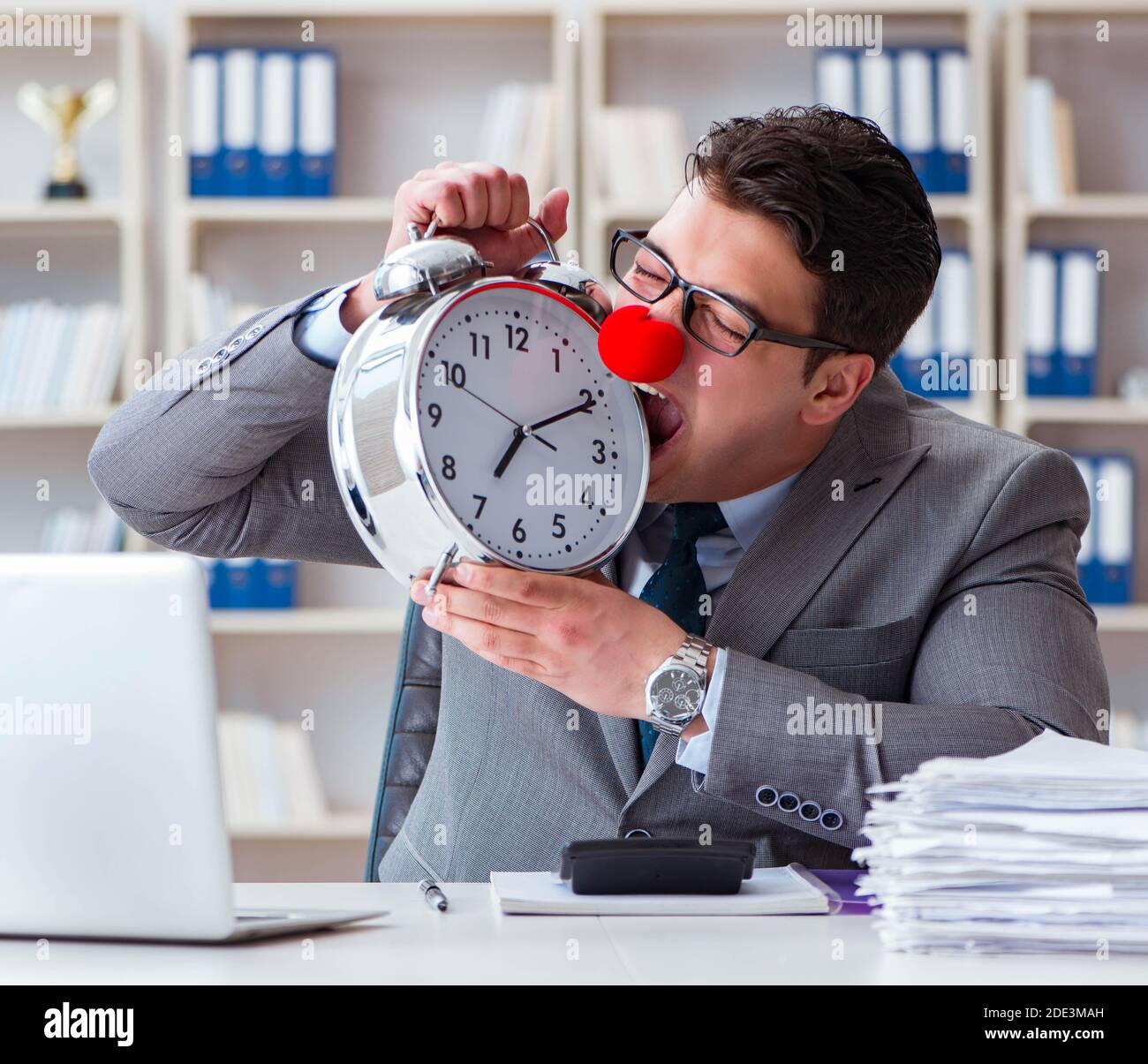 The clown businessman with alarm clock missing dieadline Stock Photo ...