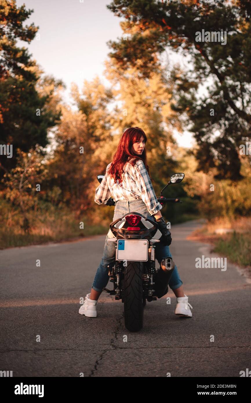 Woman sitting on back motorbike hi-res stock photography and images - Alamy