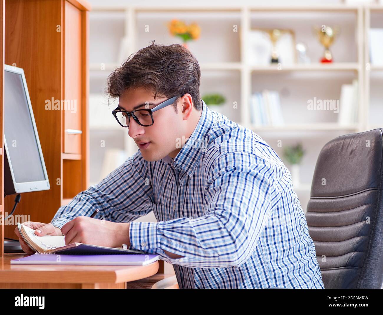 The young student at computer table Stock Photo - Alamy