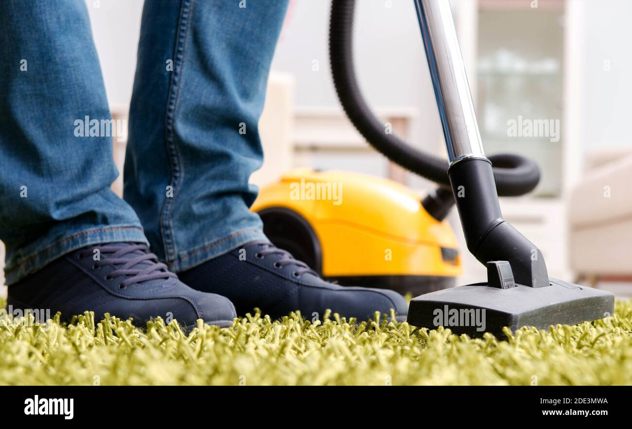 The man cleaning the floor carpet with a vacuum cleaner close up Stock ...