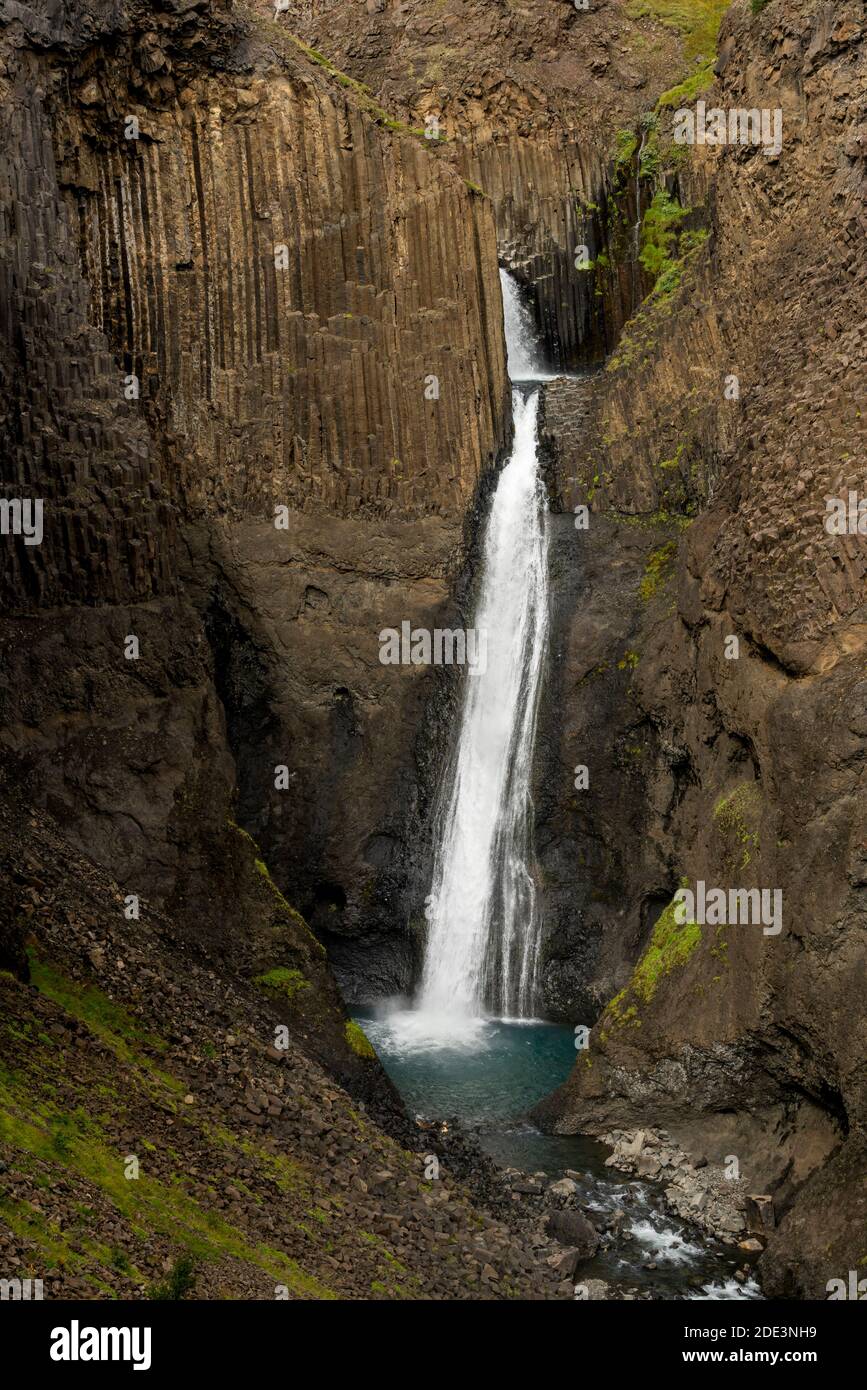 High angle view of Litlanesfoss waterfall and basalt columns, eastern ...
