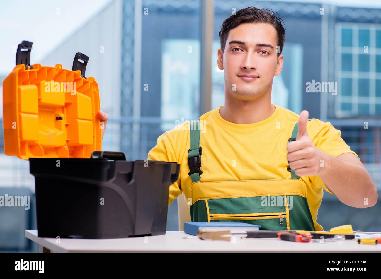 The construction worker sitting at the desk Stock Photo - Alamy