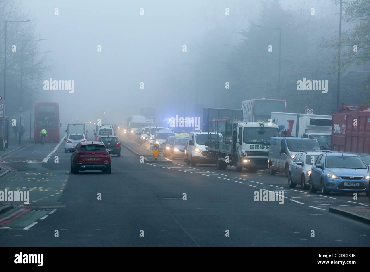 Heavy traffic in dense fog in London. Freezing cold and foggy weather ...