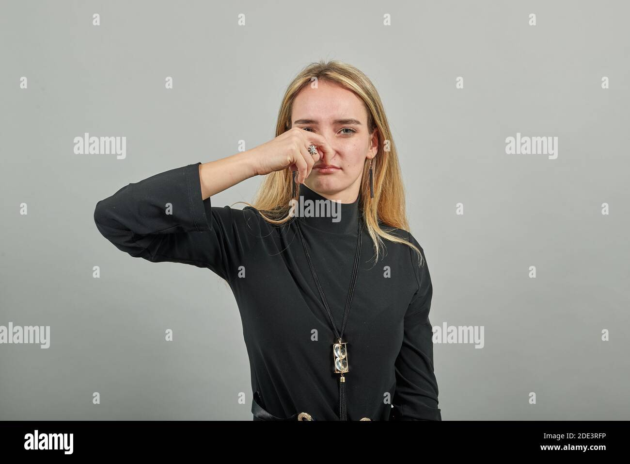 Covering nose with hand showing something stinks, isolated, hands face ...
