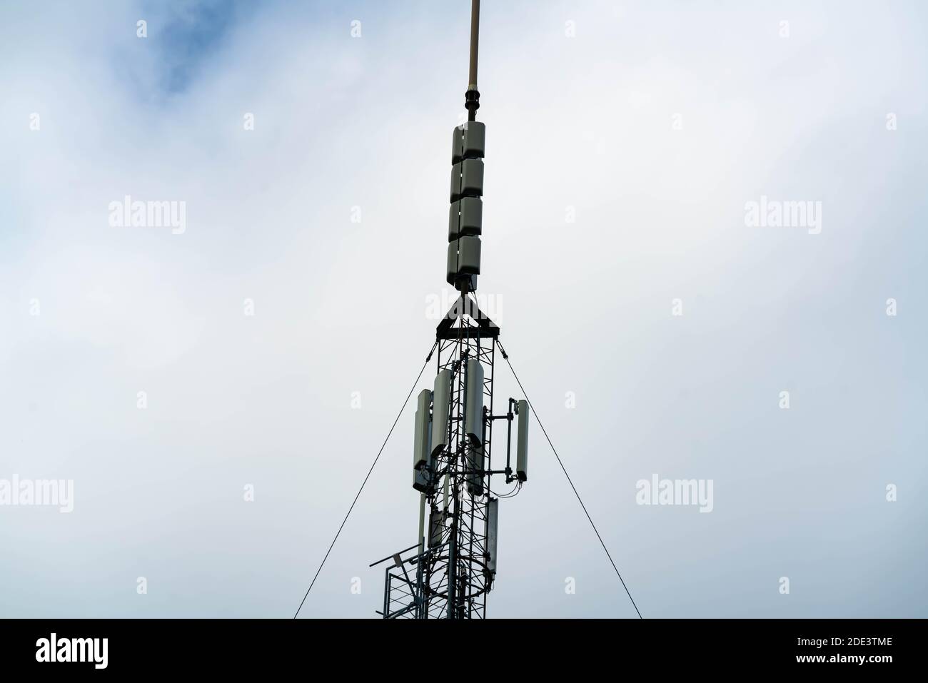 Large cellular communications tower with arrays, antennas and dishes ...