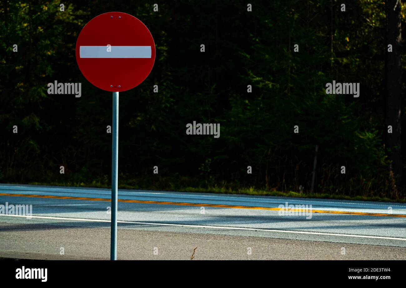 Stop or not allowed red and white road sign on the side of a highway ...