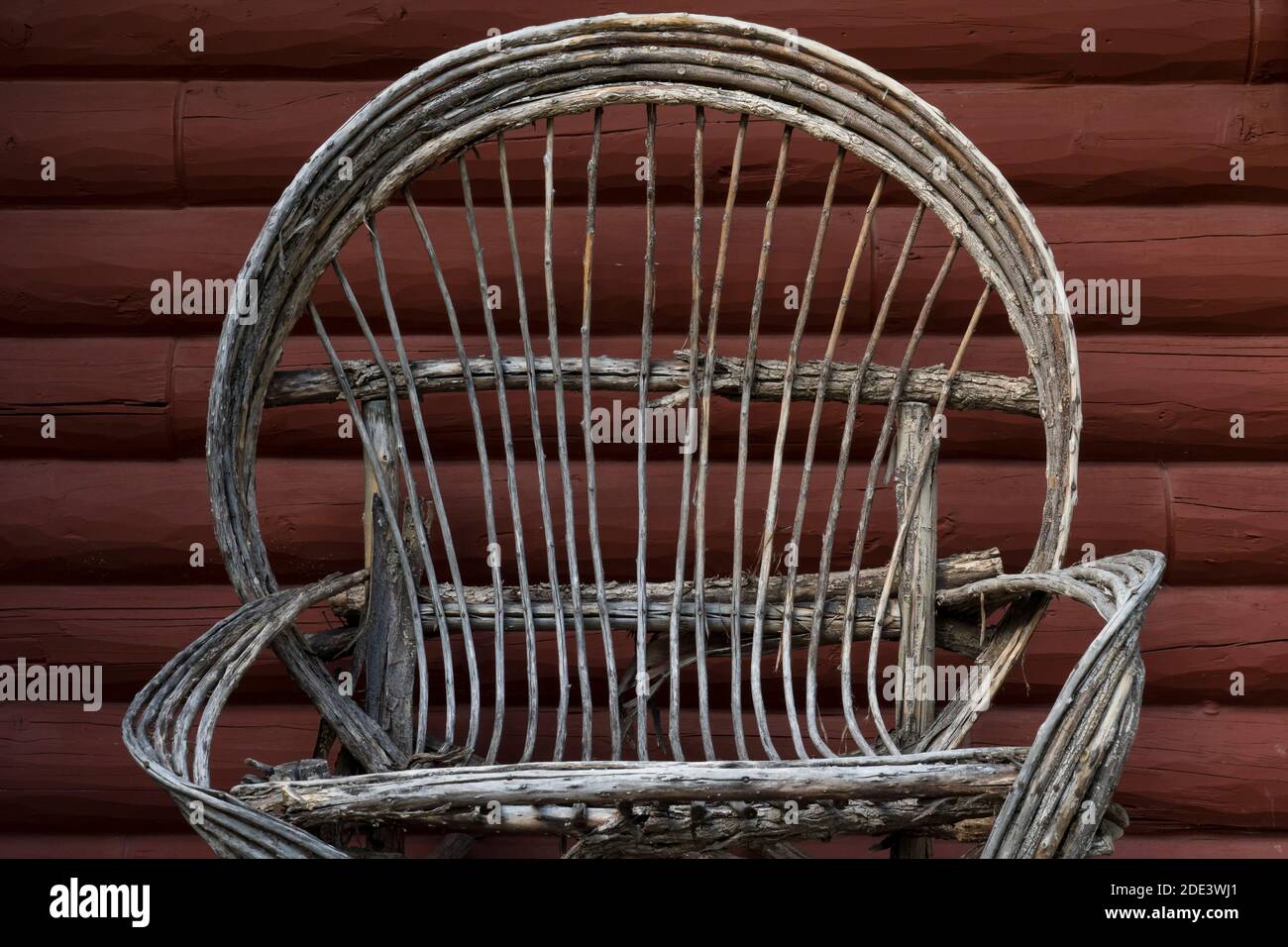 A rustic willow bench on the porch of a rustic log cabin near Helena ...
