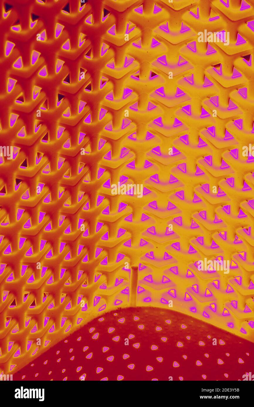 Multidimensional interwoven background pattern in deep red, yellow and ...