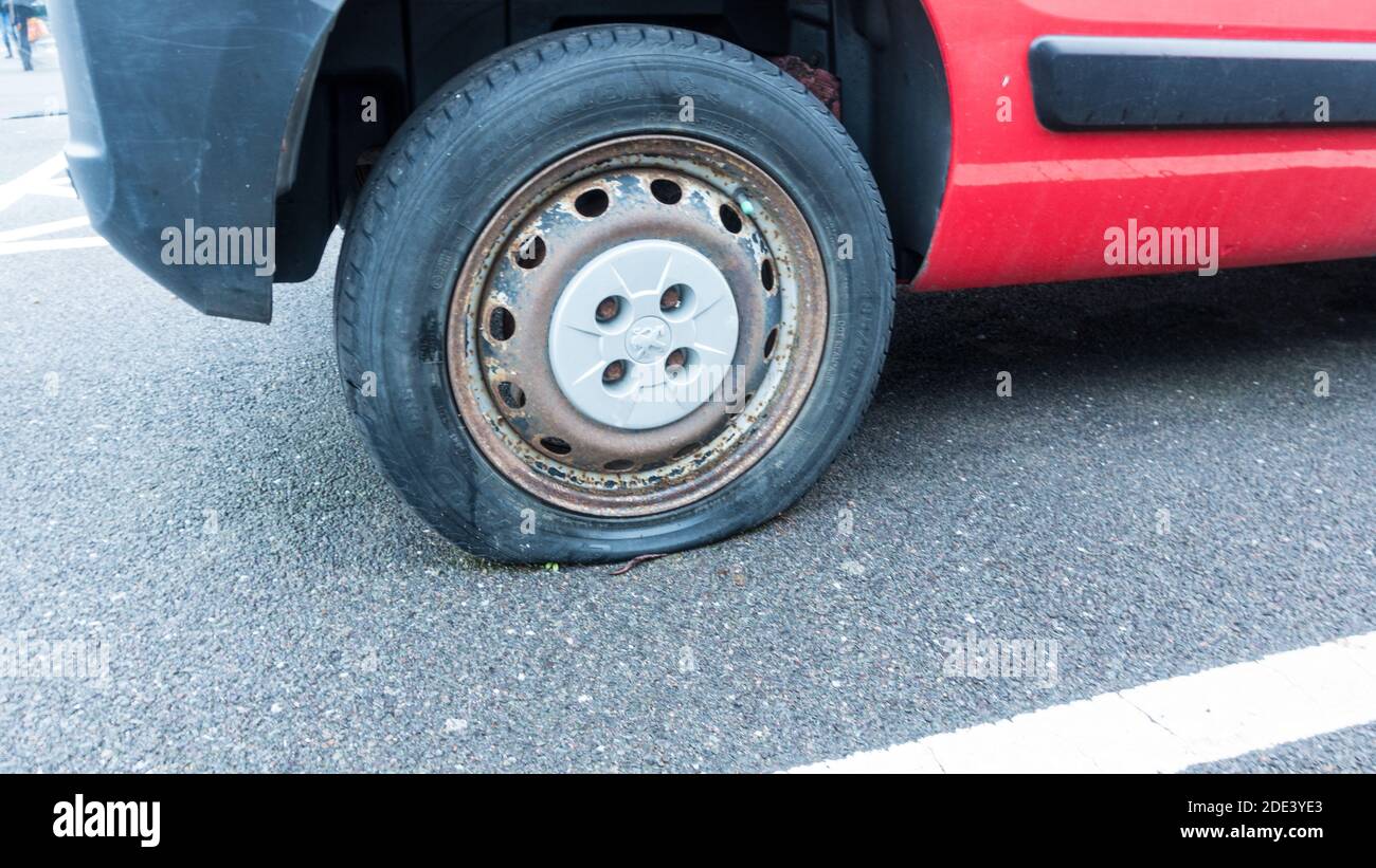 Flat tire on a old rustic rim van wheel Stock Photo - Alamy