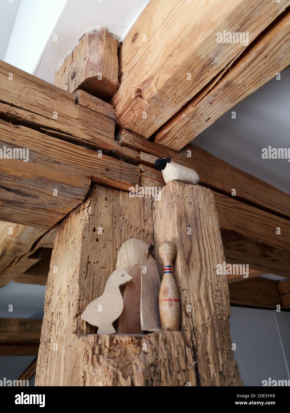 A low angle shot of wooden weathered column inside the building with ...