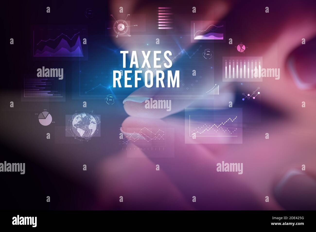 Finger touching tablet with charts and TAXES REFORM inscription ...
