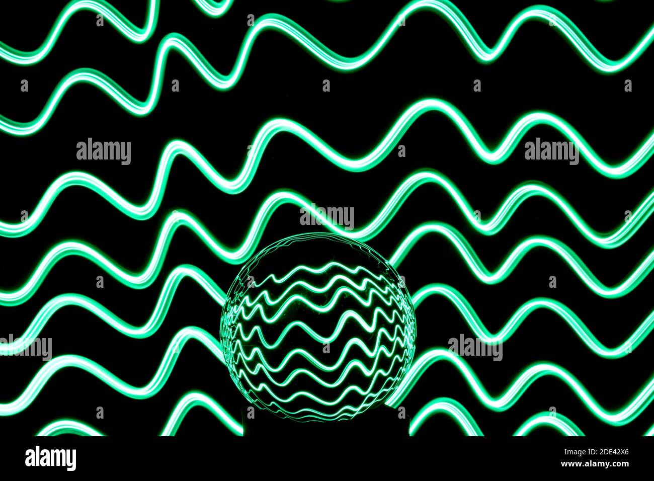 Long exposure photograph of neon green colour in an abstract swirl ...