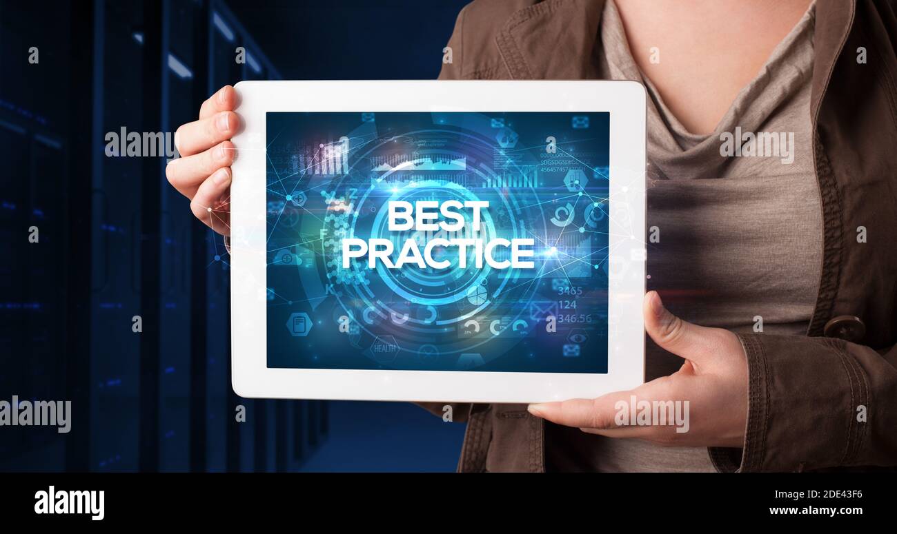 Young business person working on tablet and shows the inscription: BEST ...