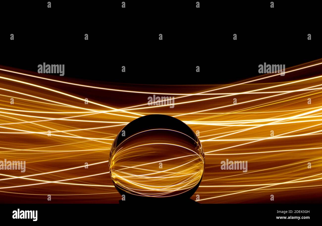 Long exposure photograph of neon gold colour in an abstract swirl ...