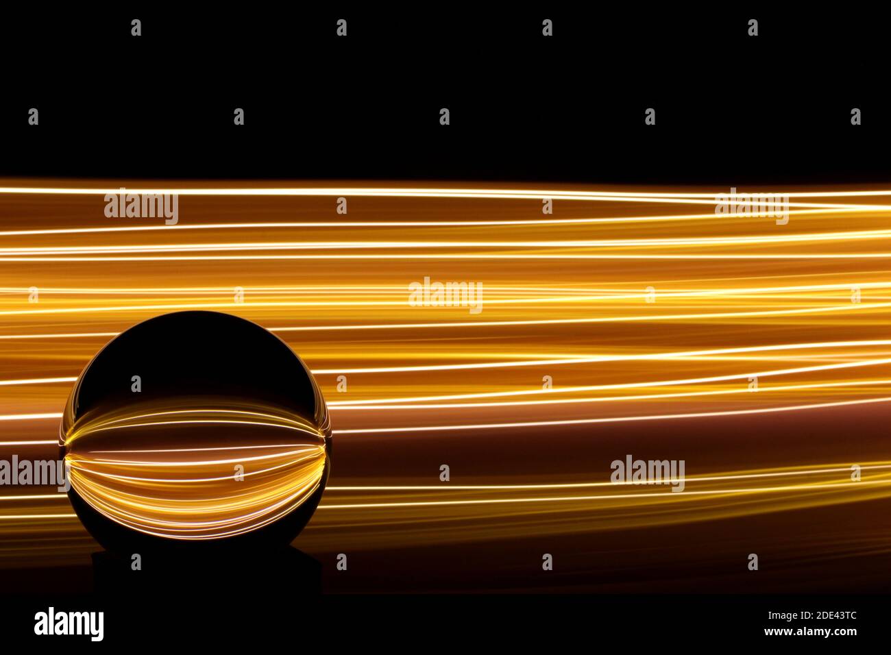 Long exposure photograph of neon gold colour in an abstract swirl ...