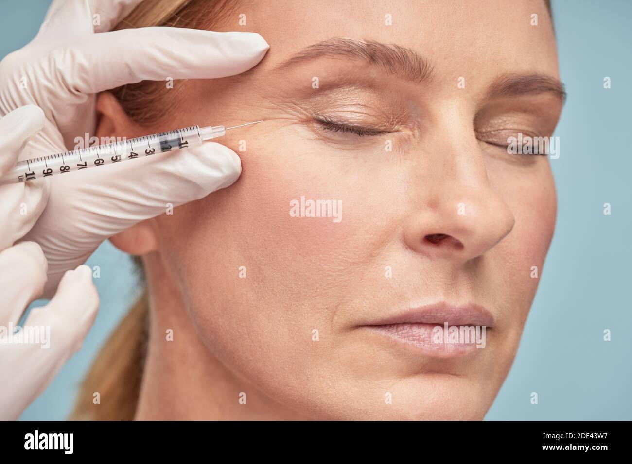 Close Up Portrait Of A Beautiful Mature Woman Keeping Eyes Closed While