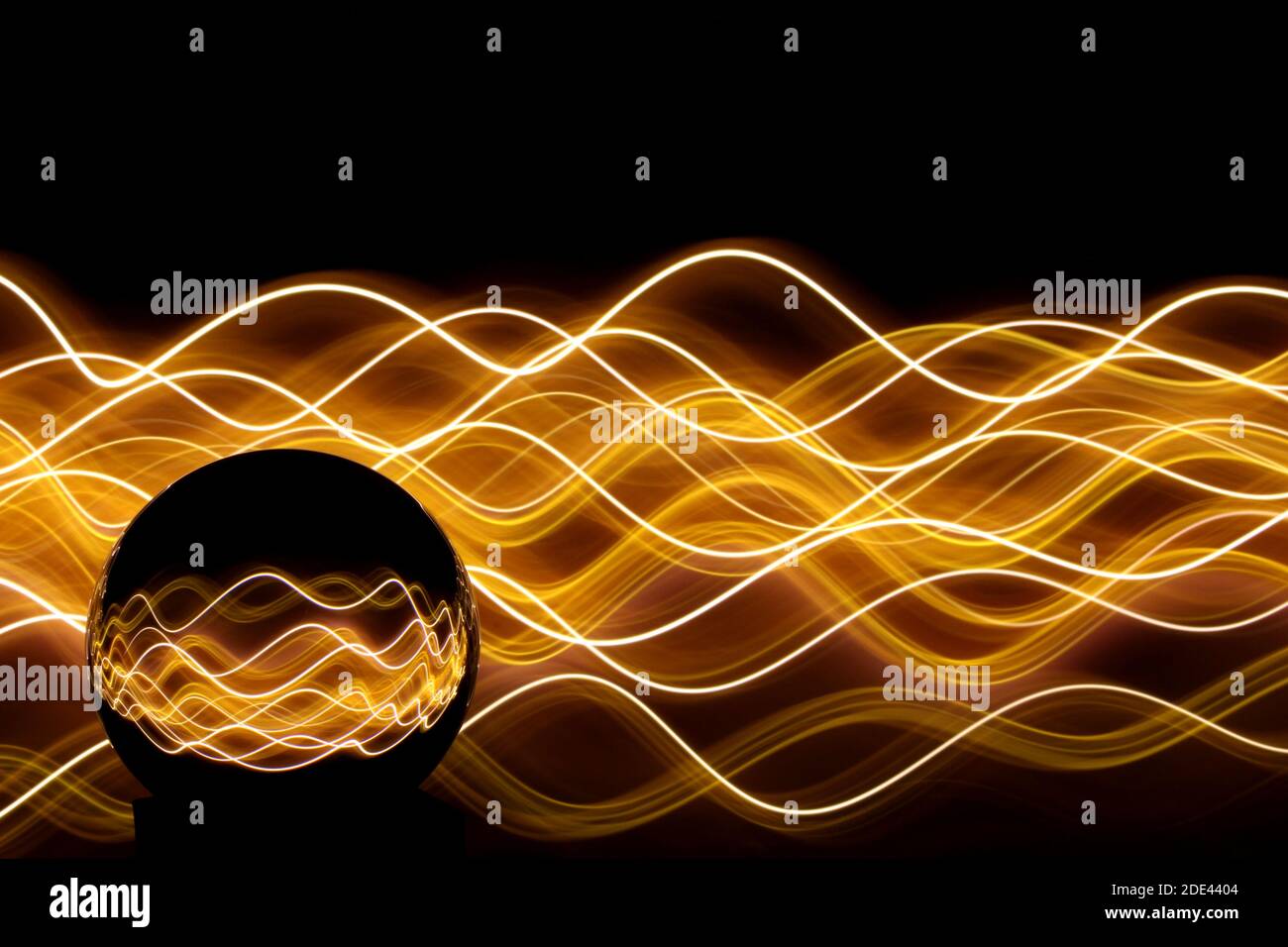 Long exposure photograph of neon gold colour in an abstract swirl ...