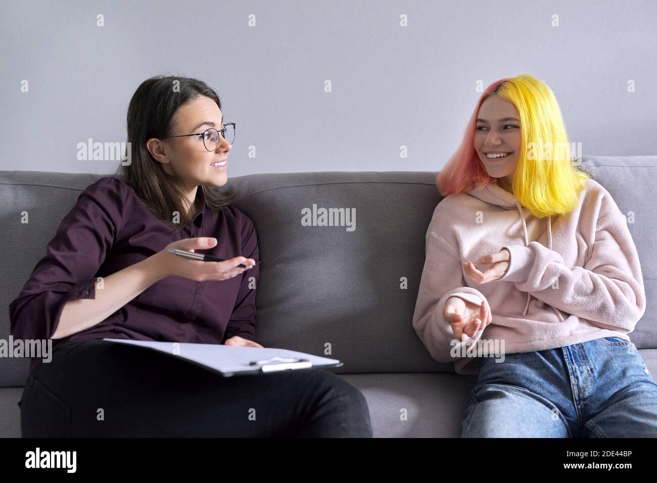 Teen girl giving interview to social worker. School psychologist ...