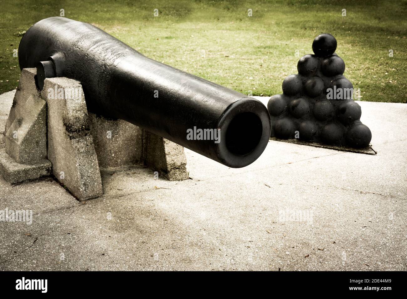 A Civil war era cannon exhibit along with a stack of cannon balls, a ...