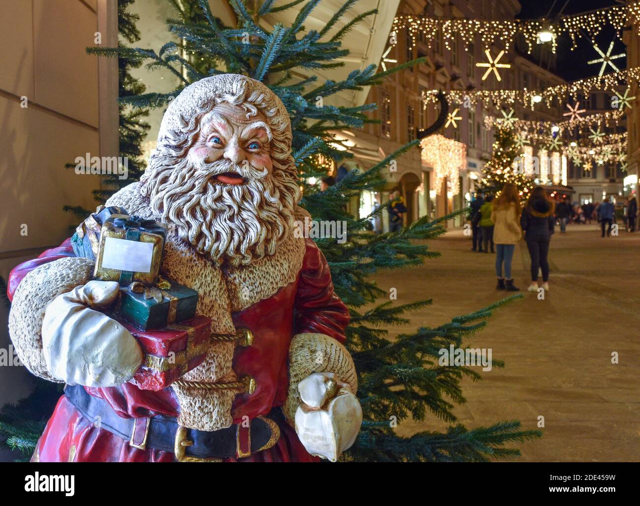 Santa Claus and beautiful Christmas decorations, at night, in the city ...