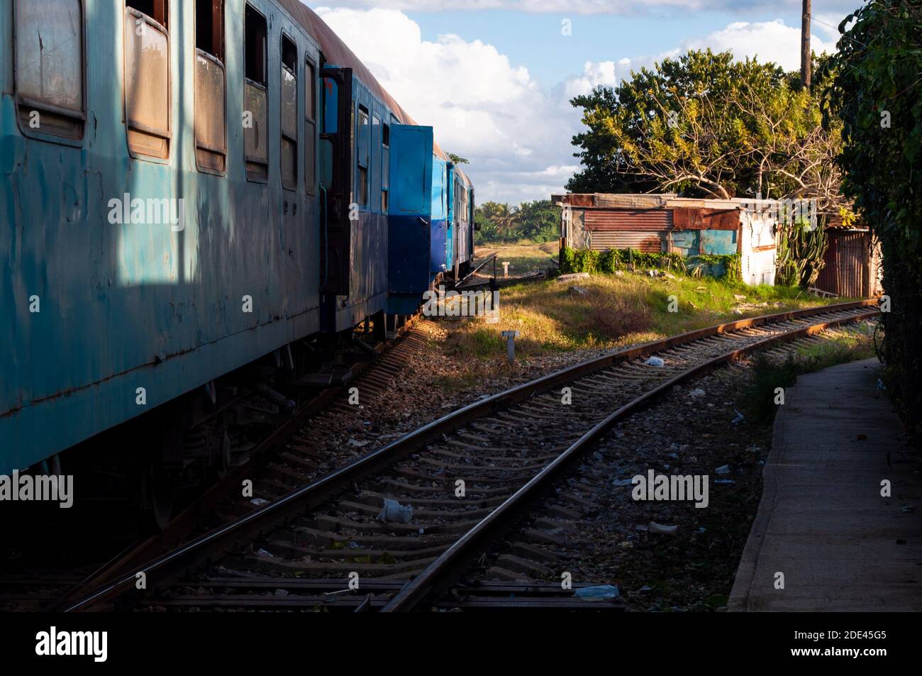 Blue wagons of an old train on the lines in a country town, sunny day ...