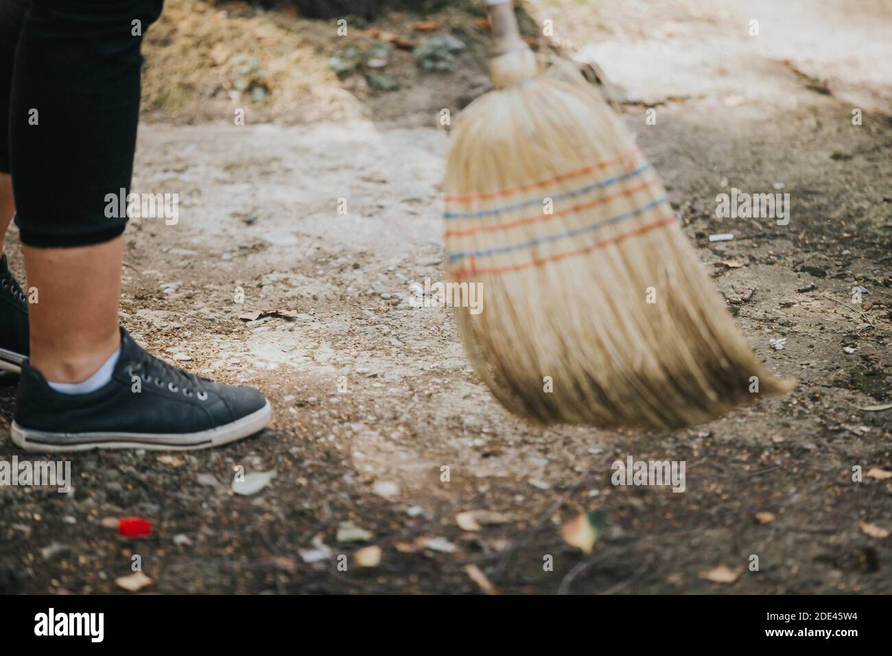 Woman sweeping street hi-res stock photography and images - Alamy